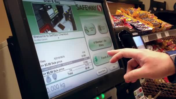 Man paying foods at self checkout counter inside Safeway. Stock Video ...