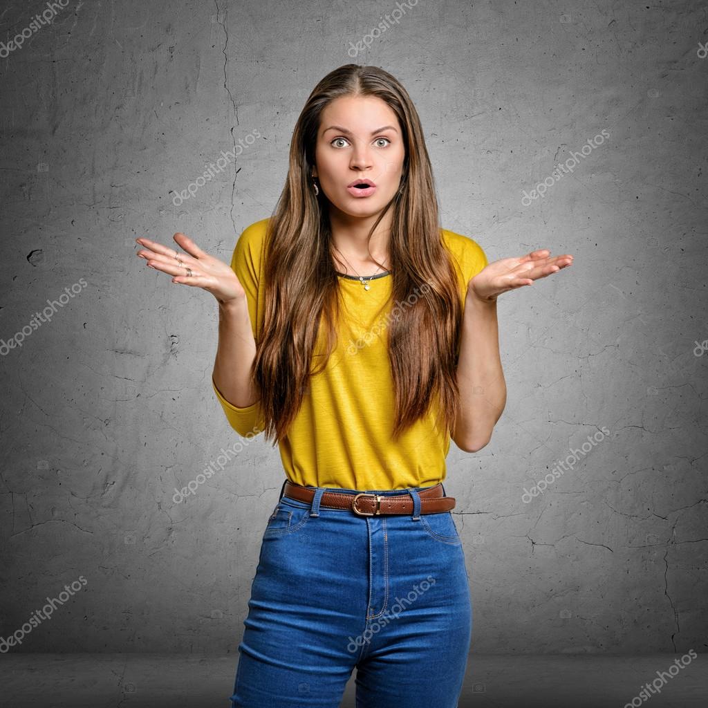Woman shrugs shoulders with palms up and astonished expression Stock ...