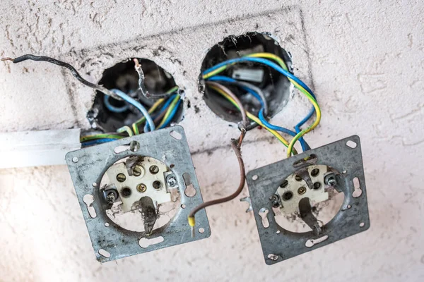 Undone AC power socket in wall. Electric plug in home improvement ...