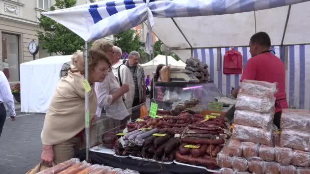 Butcher meat-man sell smoked meat sausage and ham in outdoor store. 4K ...