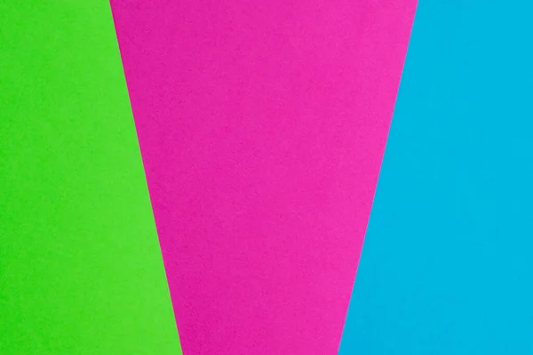 Bright paper background consisting of three colors: pink, green and ...