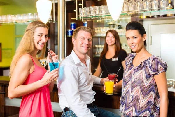 Young people with cocktails in bar - Stock Image - Everypixel