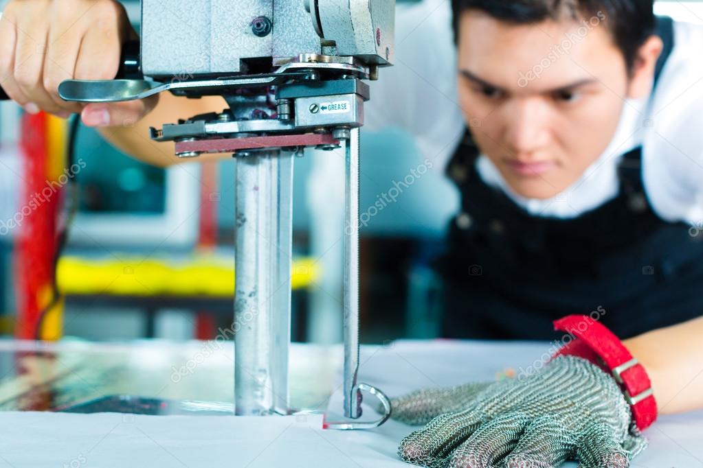 Worker using a machine in chinese factory — Stock Photo © Kzenon #69698605