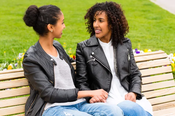 Best friends talking and having fun in park - Stock Image - Everypixel
