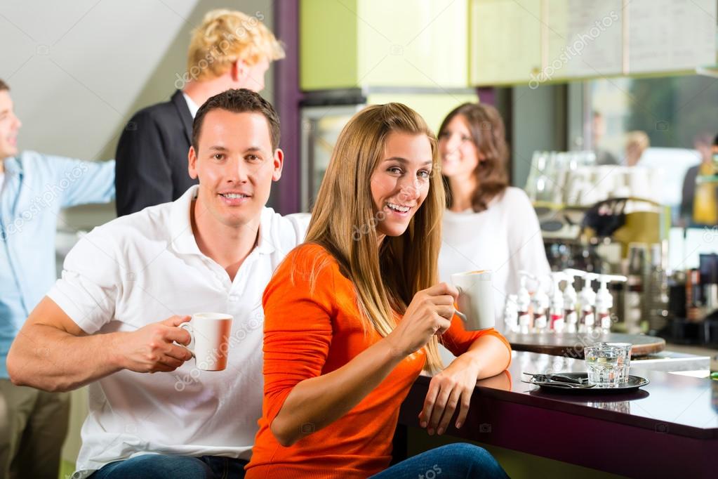 Group of people in Cafe drinking coffee — Stock Photo © Kzenon #79215708