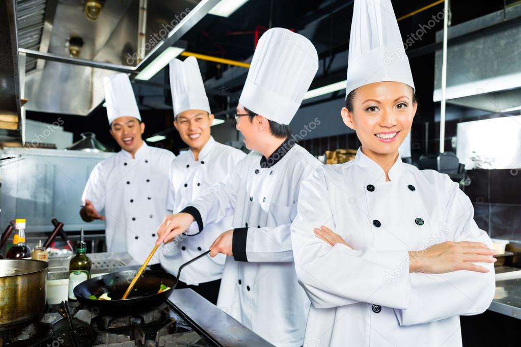 Asian Chefs in hotel restaurant kitchen — Stock Photo © Kzenon #79329522