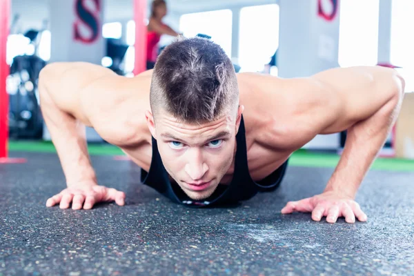 Man doing push-up in sport fitness gym - Stock Image - Everypixel