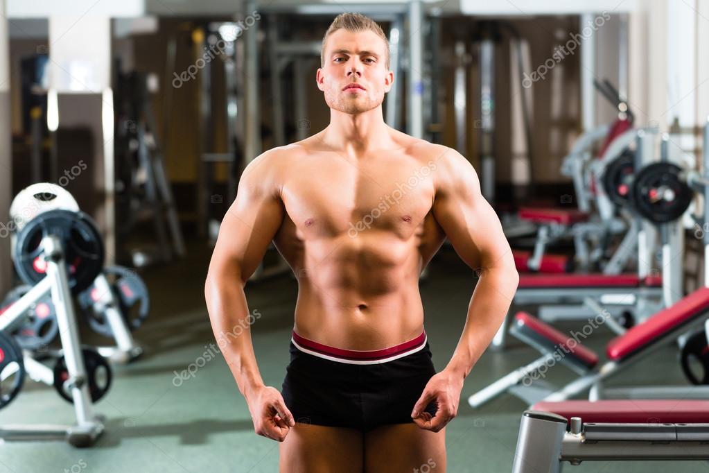 Bodybuilder posing in Gym Stock Photo by ©Kzenon 79807948