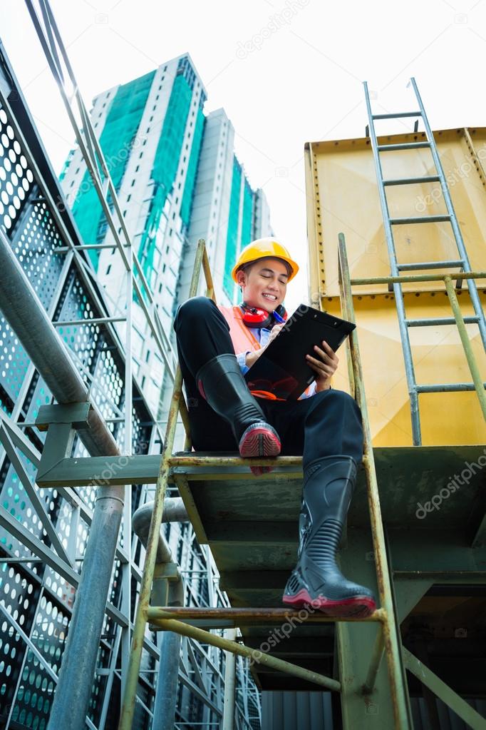 Asian Indonesian construction worker on building site Stock Photo by ...
