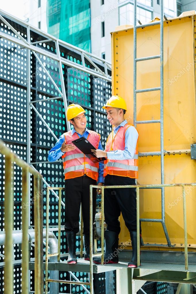 Asian Indonesian construction workers on building site Stock Photo by ...