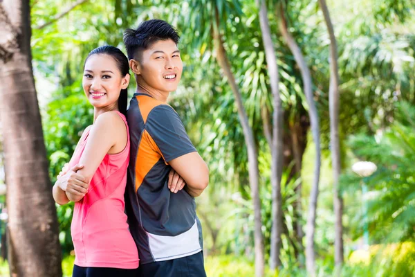 Chinese couple finish running training in park - Stock Image - Everypixel