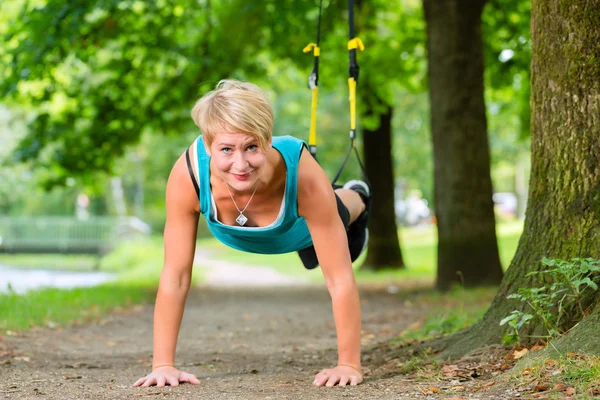 Woman doing suspension sling trainer sport - Stock Image - Everypixel