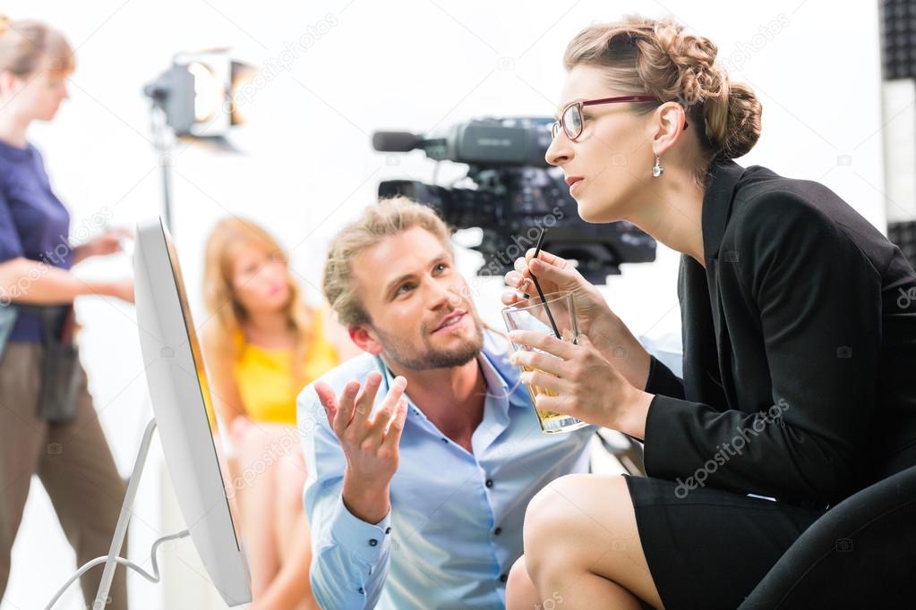 Film team discussing direction for video production — Stock Photo ...