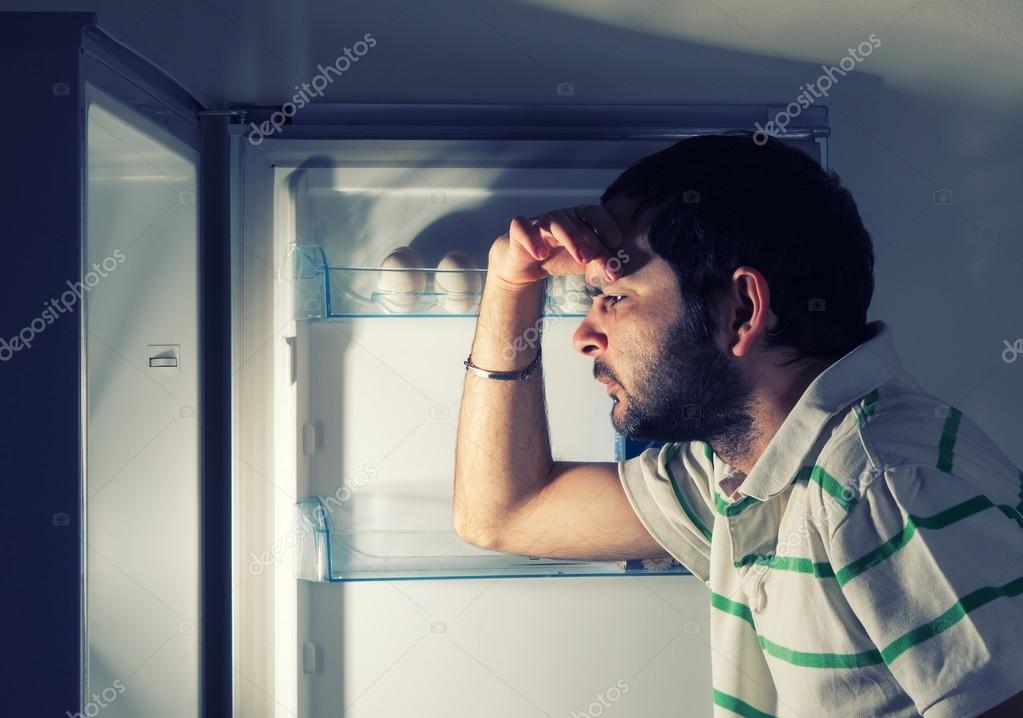 Funny man looking into refrigerator Stock Photo by ©goglik83 105936302