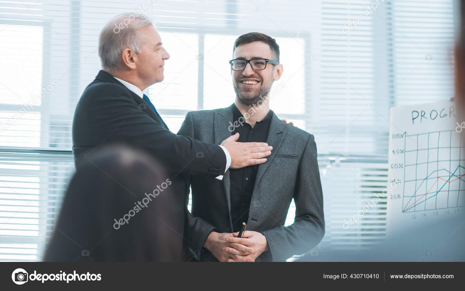 Project Manager congratulating the best employee at a meeting with the ...