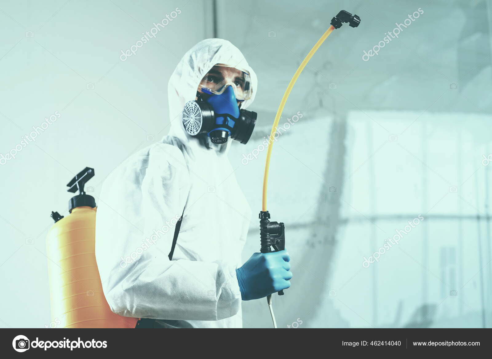 Decontamination services worker wearing personal protective equipment ...