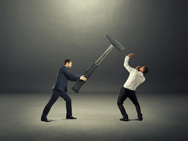 Strong fat man holding a big hammer — Stock Photo © profoto8213 #42748837