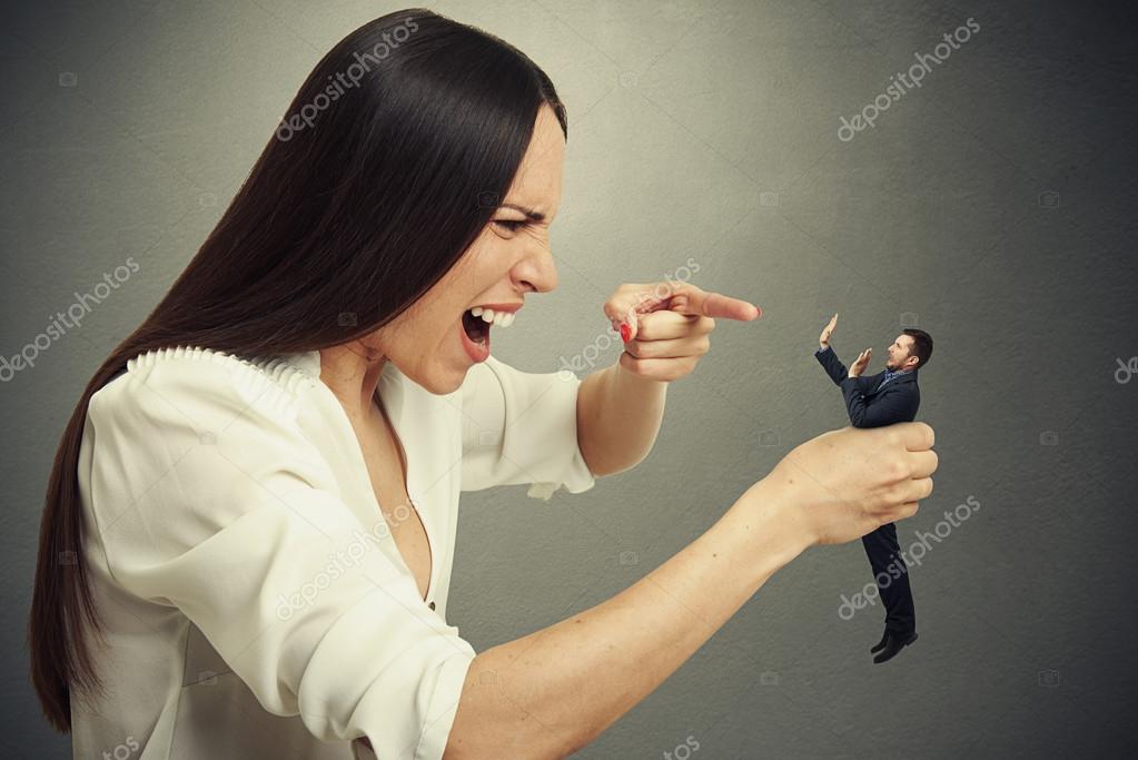 Woman holding in hand scared man — Stock Photo © konstantynov #69772495