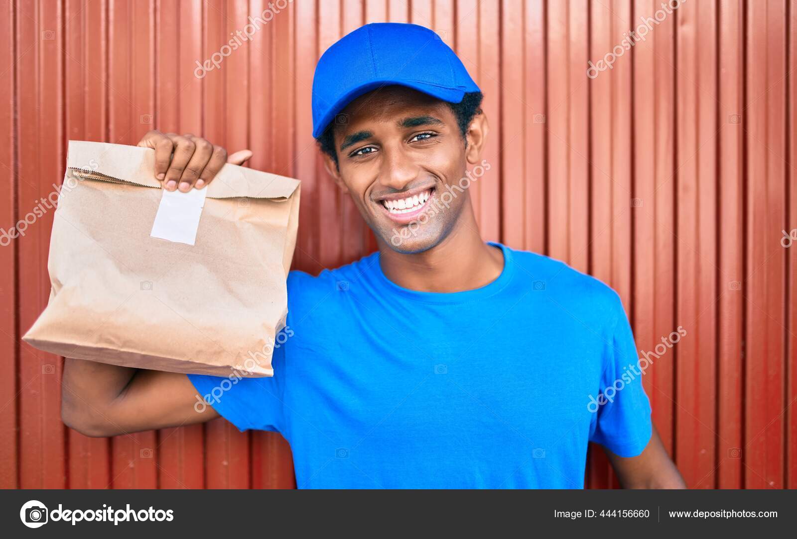 African Delivery Man Wearing Courier Uniform Outdoors Holding Take Away ...