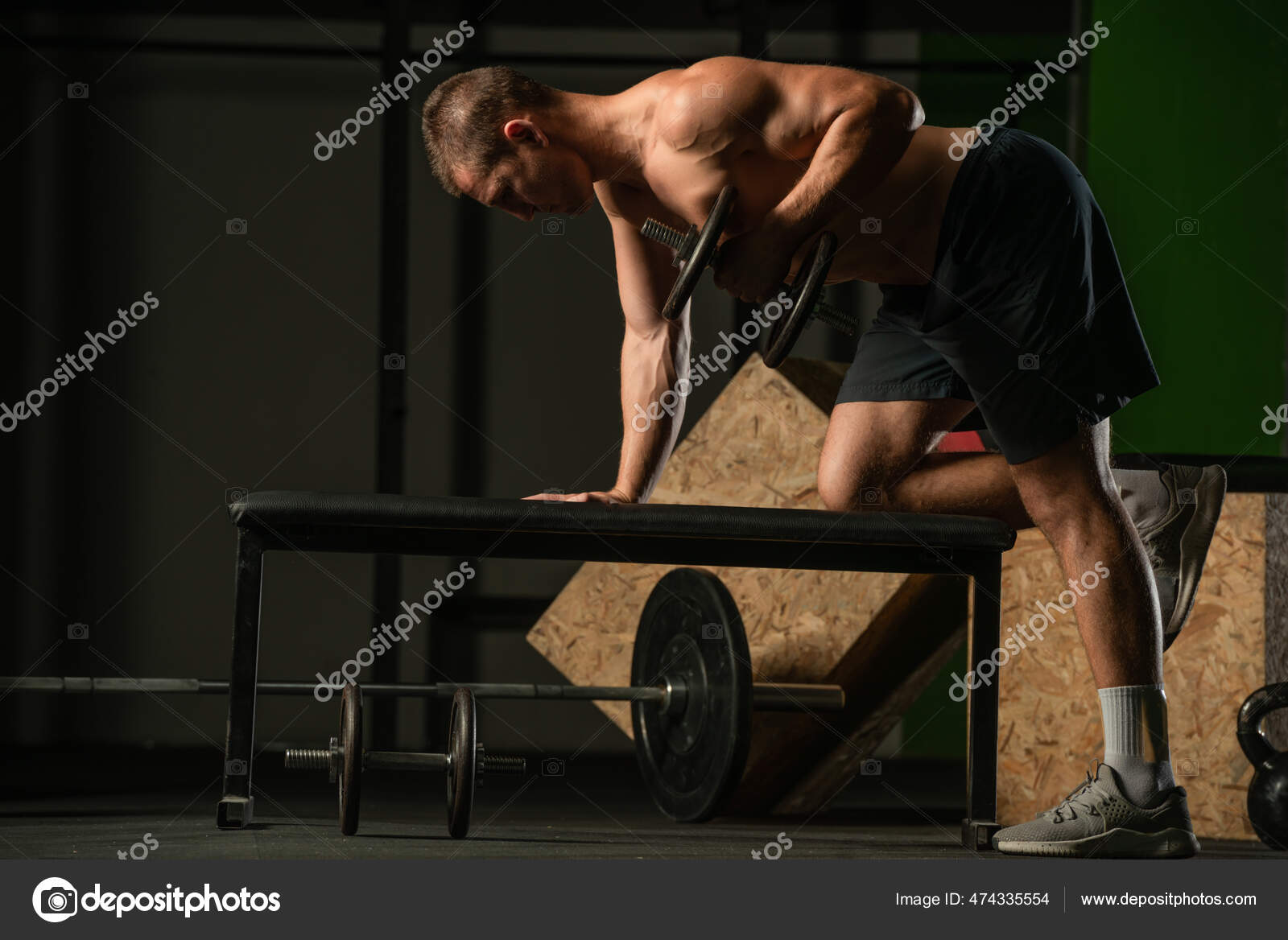 Good Looking Young Man Doing Triceps Dumbbell Kickback Exercises His ...