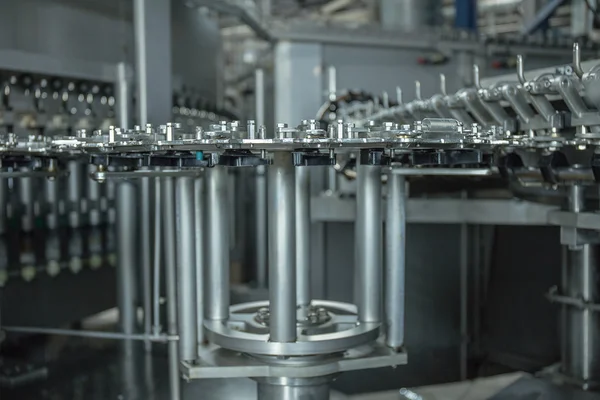 Production of plastic bottles of mineral water lemonade. spilling water ...