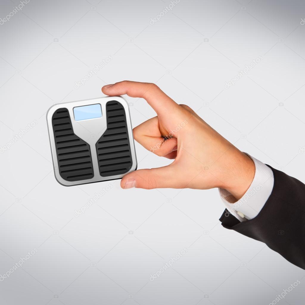 Man hand holding object (scale icon) Stock Photo by ©SectoR_2010 62864969