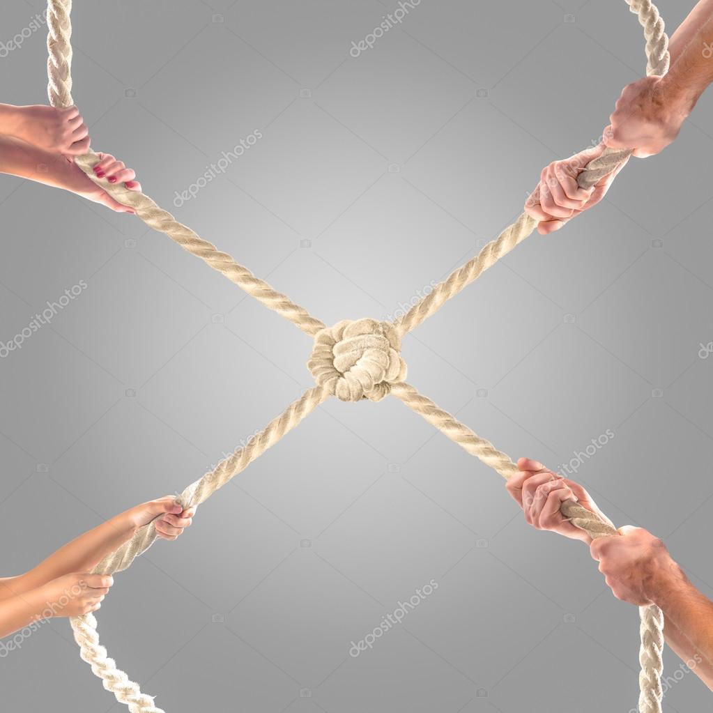 Hands of people pulling the rope on a gray background. Competition ...