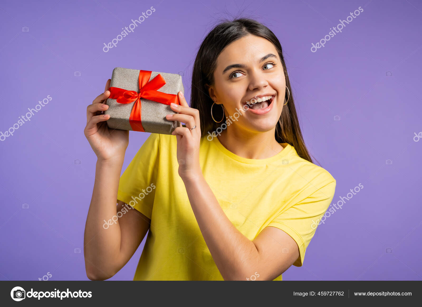 Beautiful woman received gift box with bow. She is happy and flattered ...