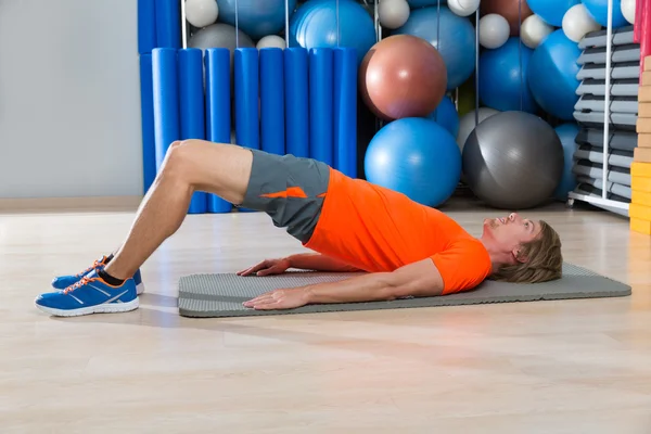 hip lift with blond man at gym workout - Stock Image - Everypixel
