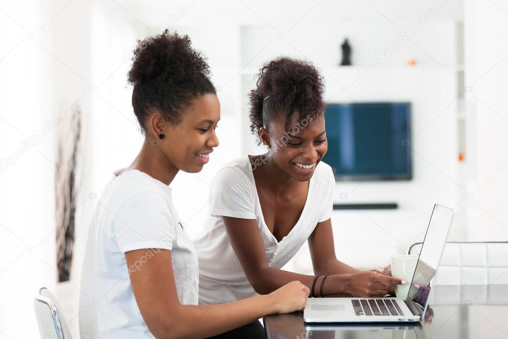 African American student girls using a laptop computer - black p ...