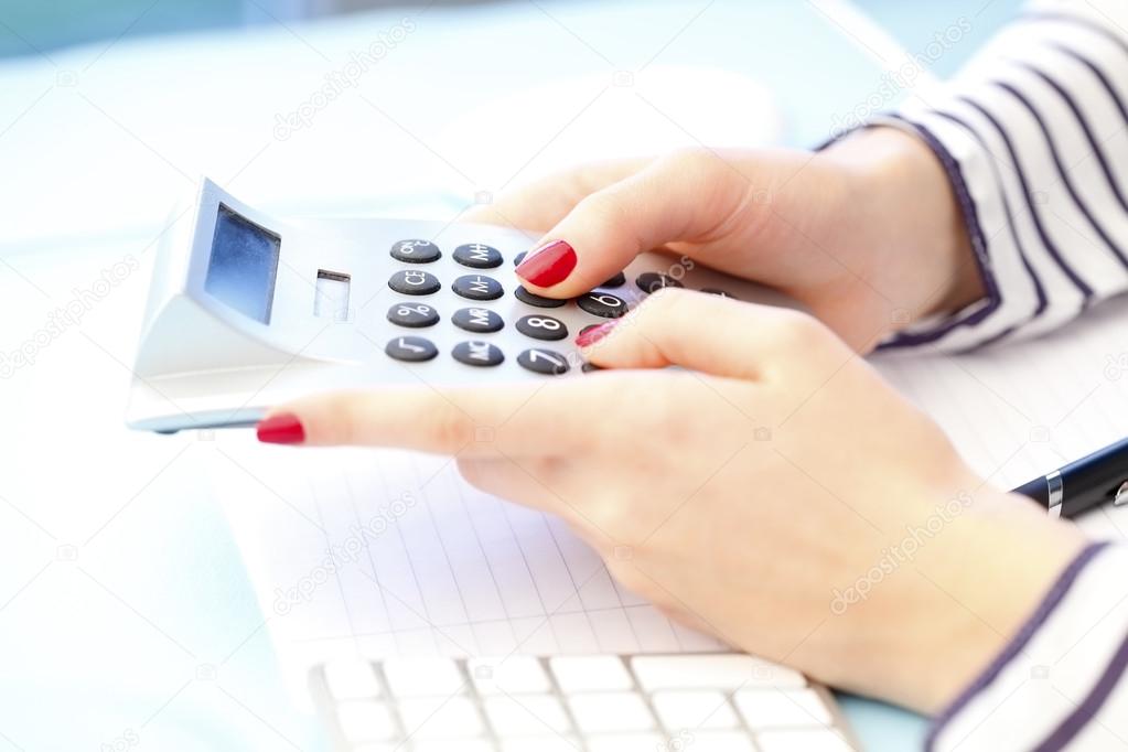 Businesswoman using calculator — Stock Photo © gzorgz #82503850