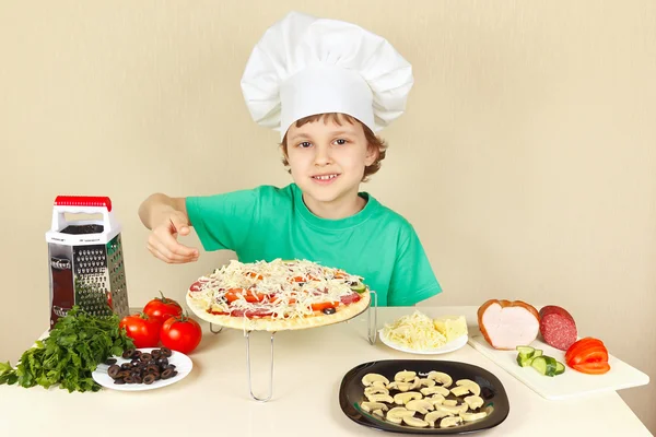 Little funny chef shows how to cook pizza - Stock Image - Everypixel