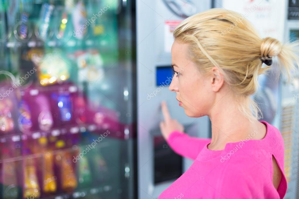 Lady using a modern vending machine — Stock Photo © kasto #52067521 Lady using a modern vending machine — Stock Photo © kasto #52067521