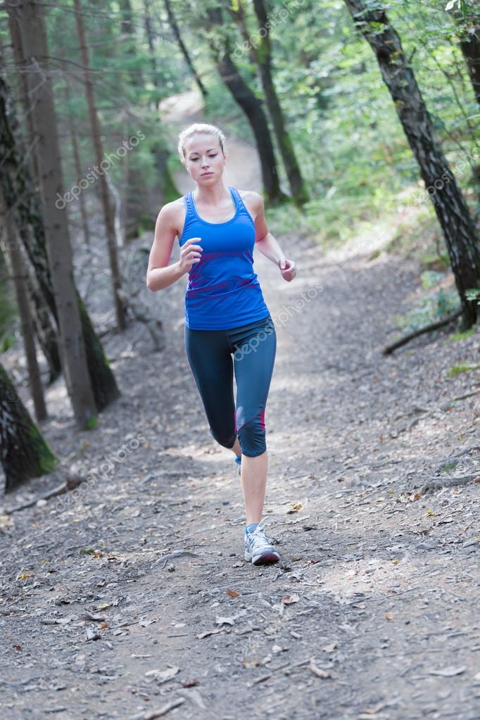 Pretty young girl runner in the forest. Stock Photo by ©kasto 58770785