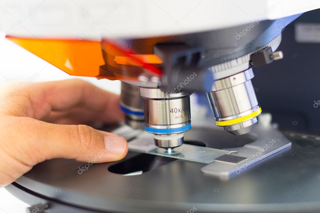 Scientist microscoping on fluorescent microscope. — Stock Photo © kasto ...