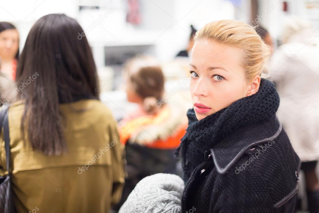 Female shopper queuing in line at cashier. Stock Photo by ©kasto 75827937