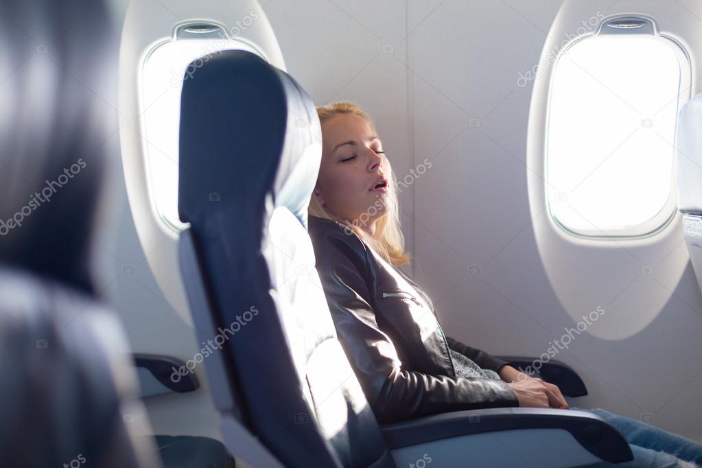 Lady traveling napping on a plain. Stock Photo by ©kasto 81764296