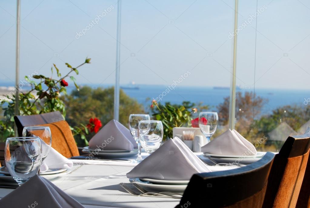 Empty Restaurant, table and chairs Stock Photo by ©sserdarbasak 109650306