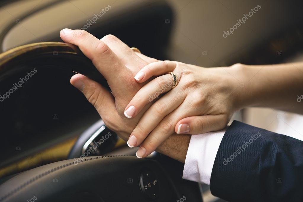 Couple Holding Hands While Driving