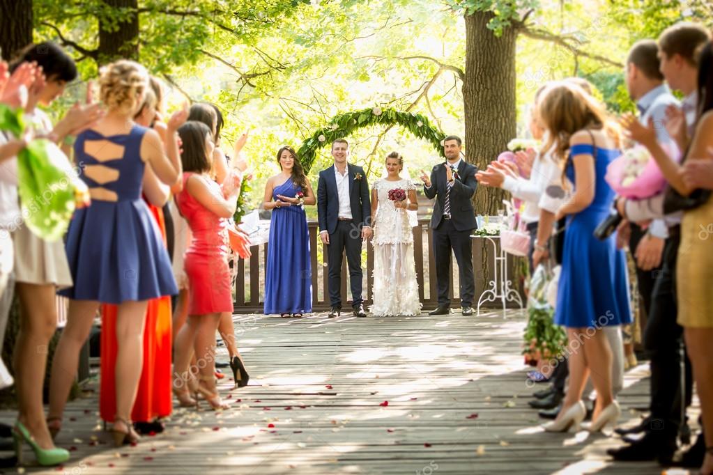 Outdoor wedding ceremony at park with lot of guests Stock Photo by ...