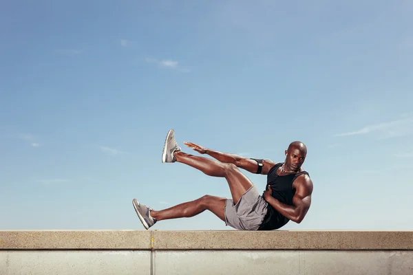 Fit young guy doing stretching workout - Stock Image - Everypixel