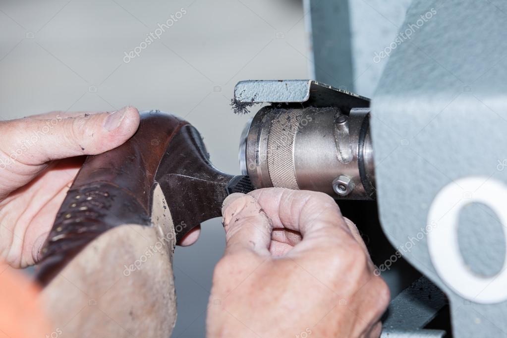 Shoemaker repairs a shoe Stock Photo by ©Chretien 51830195