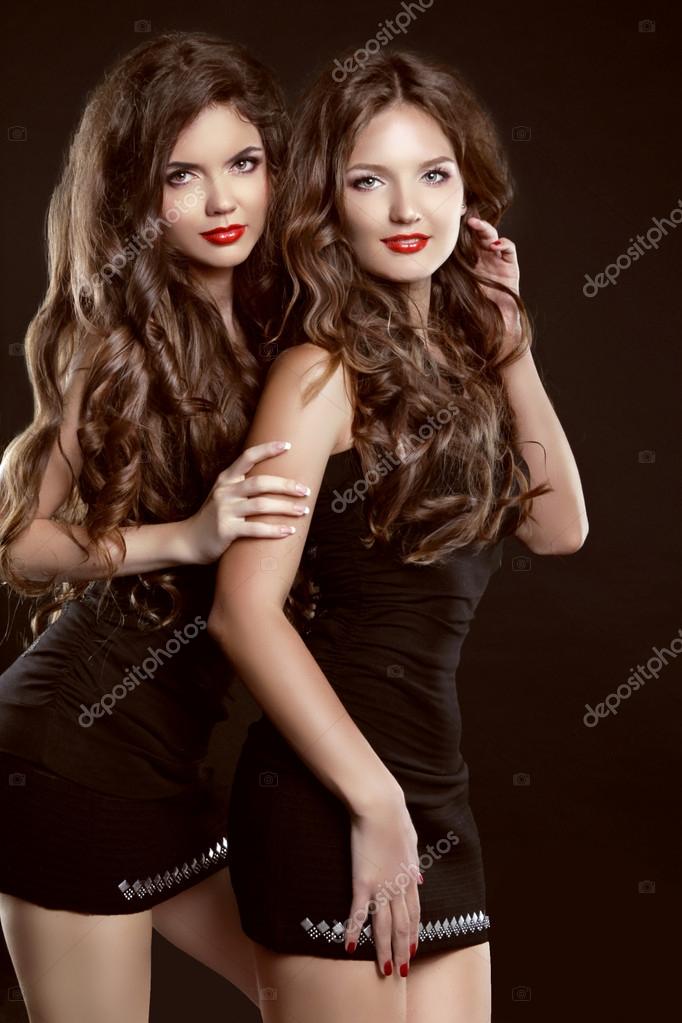 Beautiful two Young women with long healthy wavy hair styling an Stock ...