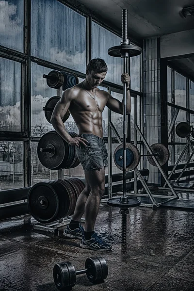 Athlete in old rusty gym - Stock Image - Everypixel