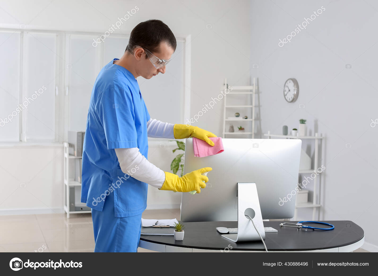 Male Janitor Cleaning Computer Office Stock Photo by ©serezniy 430886496