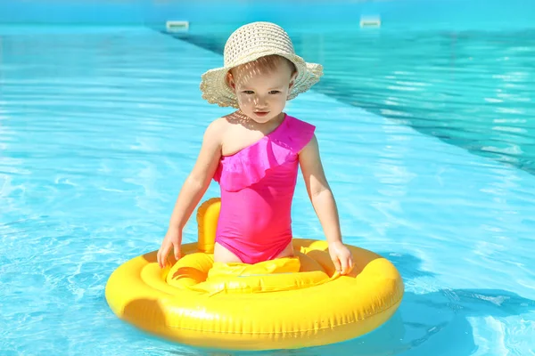 Cute little girl with inflatable ring on grey background — Stock Photo ...