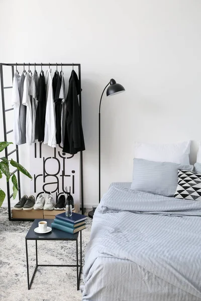 Interior of stylish bedroom with clothes rack - Stock Image - Everypixel