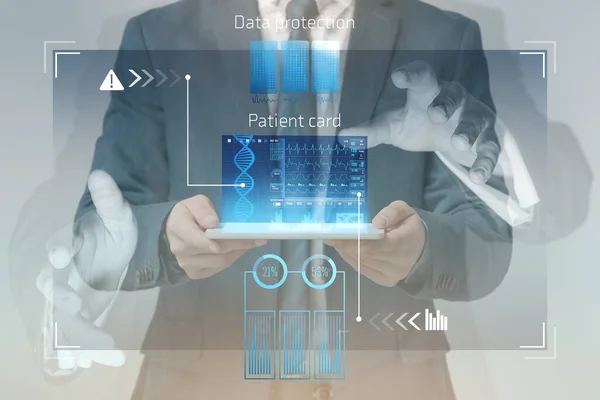 Man with tablet computer and interface of electronic patient record ...