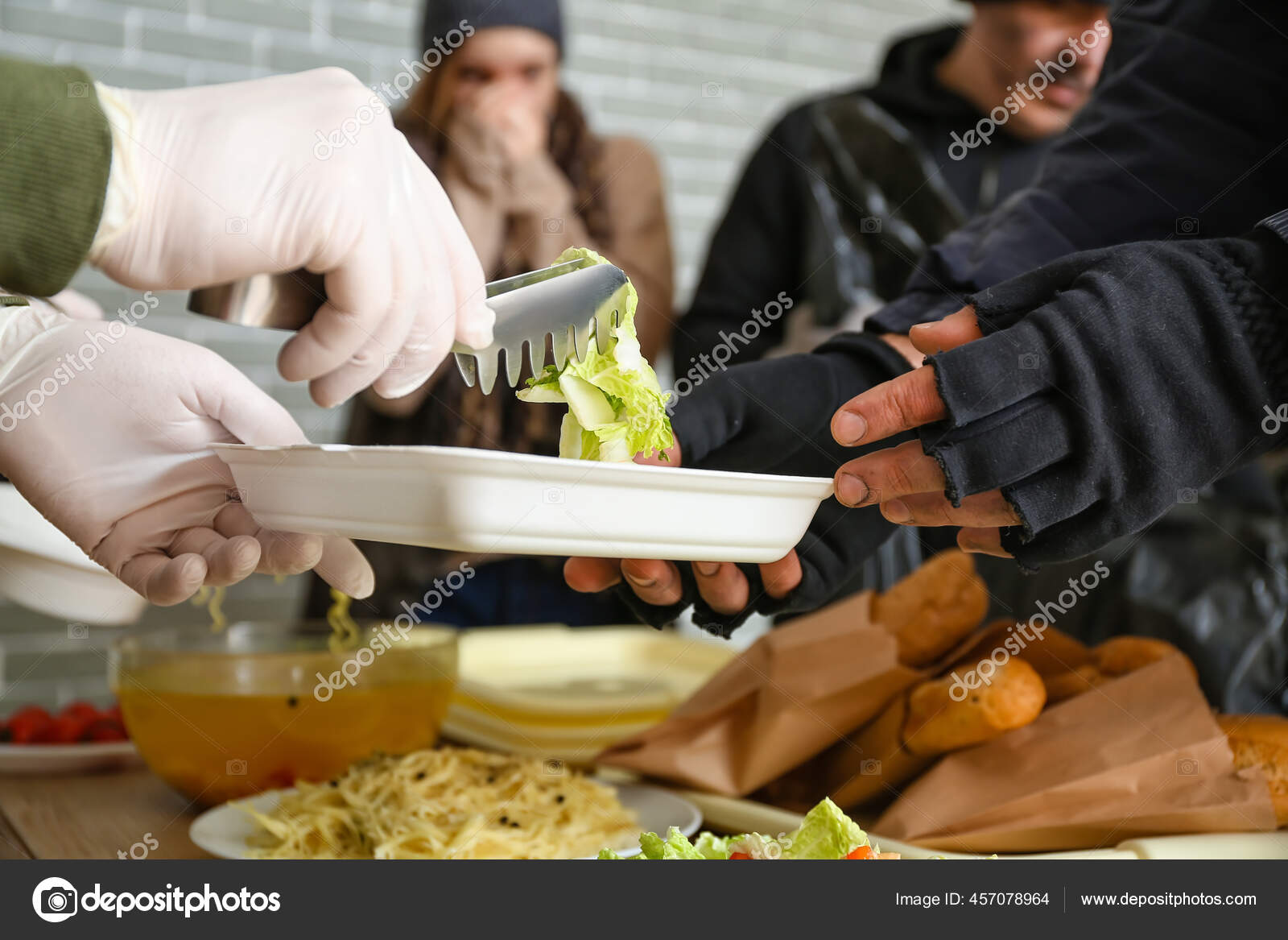 People Giving Food To The Homeless