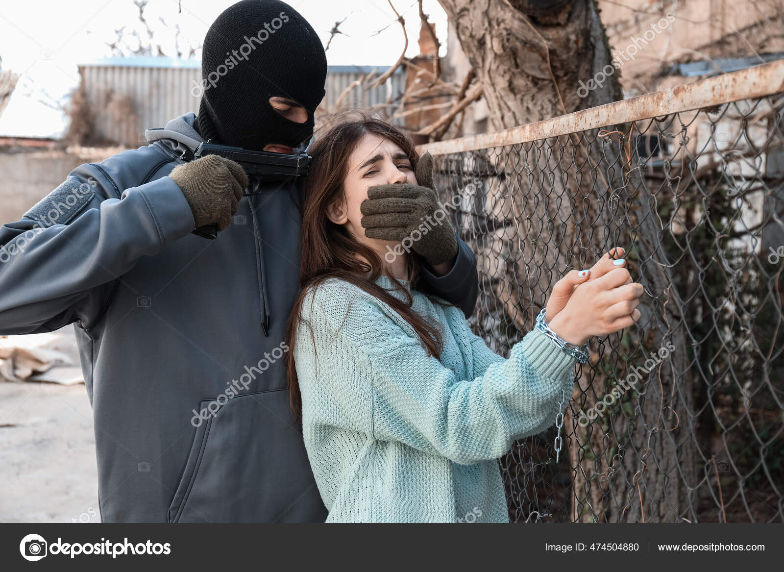 Terrorist Aiming Female Hostage Outdoors — Stock Photo © serezniy ...